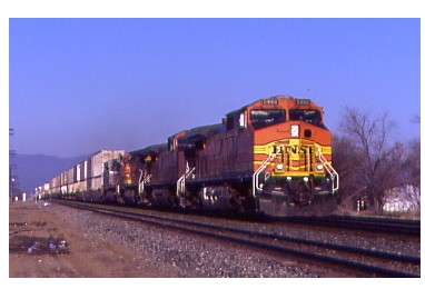 BNSF 5488 East highballing through Tehachapi with a Kansas City Southern locomotive trailing.