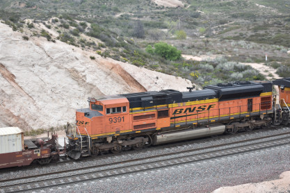 BNSF 8022 West with middle DPUs 6699 and 8244 and rear DPUs 3914 and 3032.