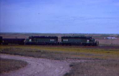 BN SD-45's 6442 and 6425 took a train through Cutbank,MT in August of 1977.