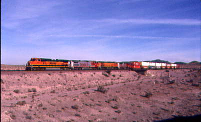 An Early morning finds the BNSF 970 East crossing one of the steel bridges on Ash Hill. 2/13/1999
