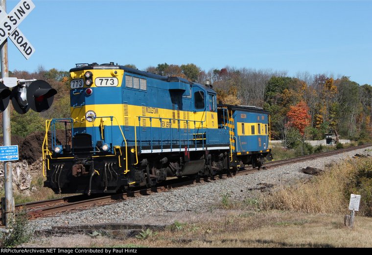 MNJ 773 (ex AMTK 773 nee QNSL 100 with caboose 380 in new paint scheme enroute to Applefest 2014.